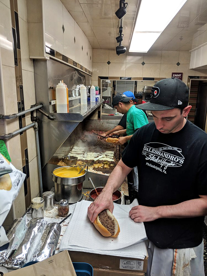 Witness the masters at work. That choreographed efficiency comes from years of practice creating the perfect cheesesteak.