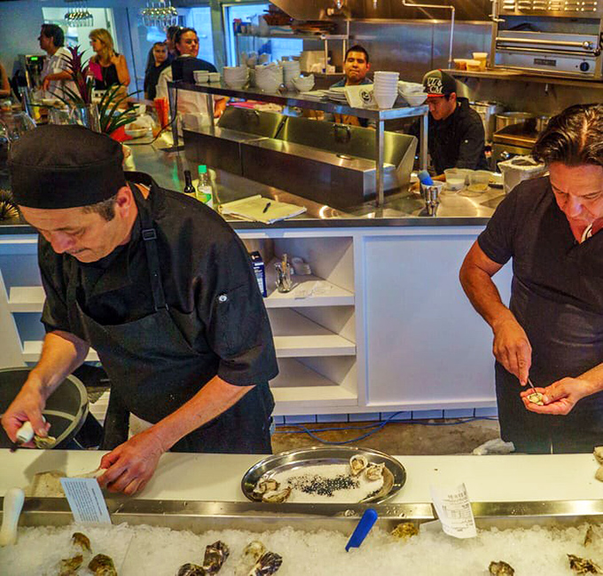 Behind the scenes where the magic happens – skilled hands transforming ocean treasures into dishes that make you close your eyes when you take the first bite.