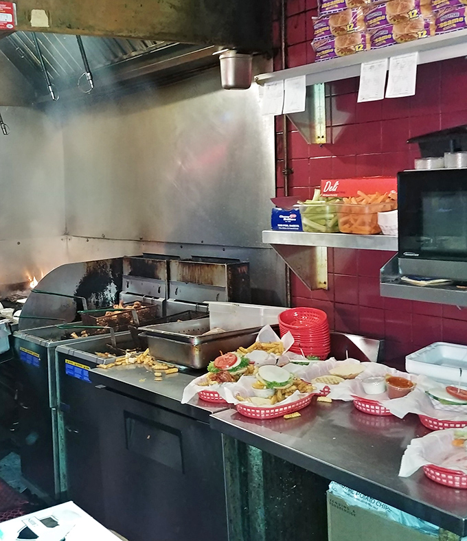 The open kitchen where burger magic happens – no smoke, no mirrors, just honest cooking that speaks for itself.
