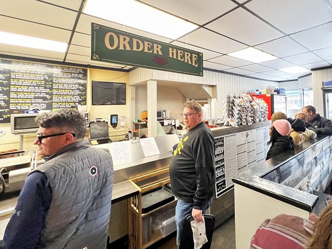 The "Order Here" sign hangs like the North Star, guiding hungry pilgrims toward their sandwich destiny with straightforward Midwestern efficiency.