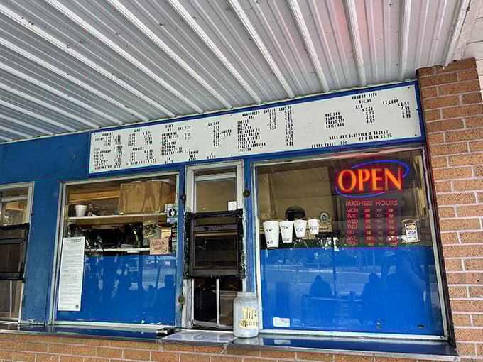 The blue-framed order window has heard thousands of "Famous Fish, please" requests. Simple signage, straightforward service, and food worth the wait.