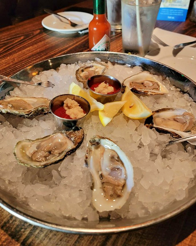 Fresh oysters on ice with lemon wedges and cocktail sauce &ndash; nature's perfect appetizer. The ocean's version of "Here's a little something to tide you over."
