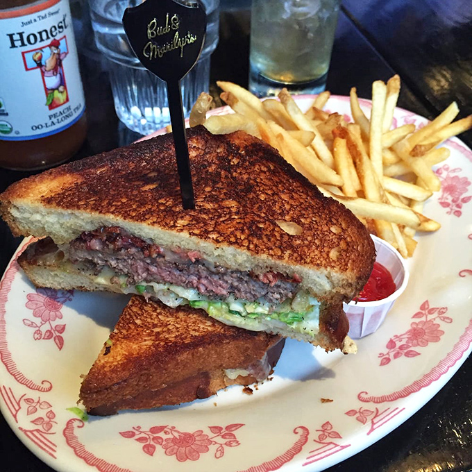 The burger that launched a thousand cravings, perfectly bisected to reveal its medium-rare soul and melty cheese heart.