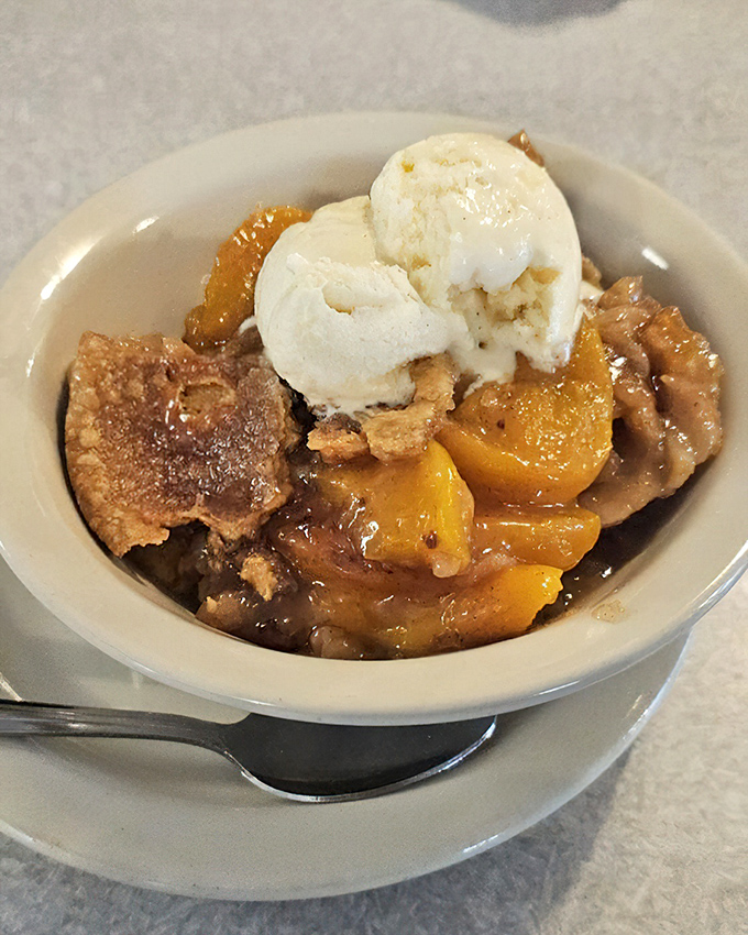 Peach cobbler topped with ice cream - summer sunshine in a bowl, regardless of what season it happens to be outside.