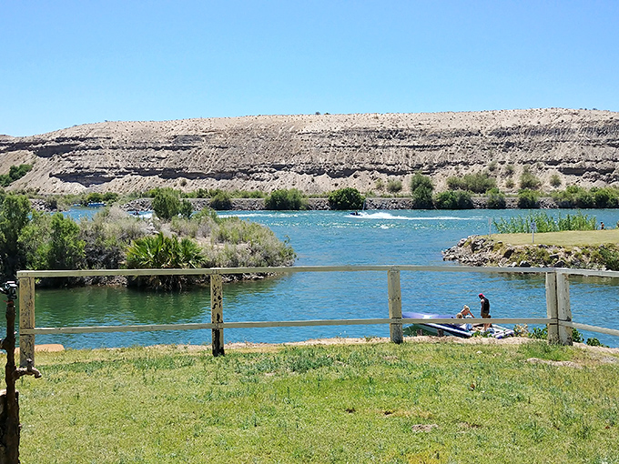 Where water meets desert, life flourishes in vibrant greens, creating recreational playgrounds that belie the surrounding aridity.