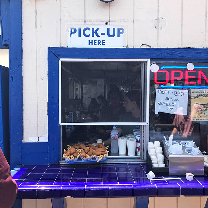 "Pick-up Here" – three simple words that signal you're moments away from burger nirvana at The Spot's efficient service window.