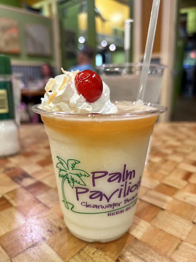 Vacation in a glass! Their signature Pi&ntilde;a Colada arrives crowned with whipped cream and a cherry&mdash;liquid sunshine with a tropical twist.