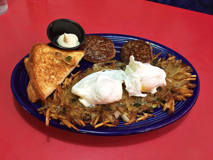 Breakfast perfection on a blue plate. Those hash browns are the unsung heroes &ndash; crispy on the outside, tender within, like the best of us.