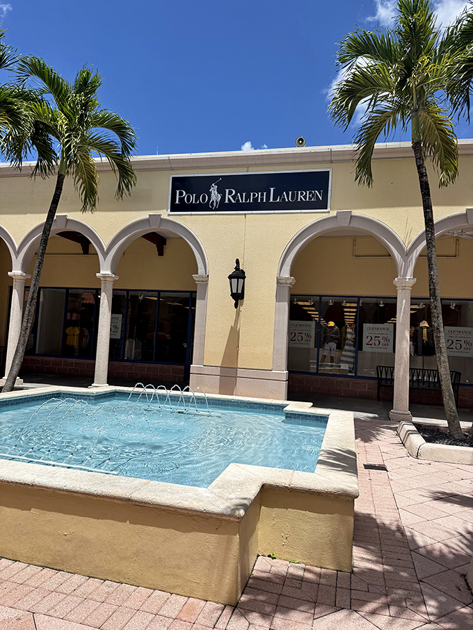Polo Ralph Lauren's storefront complete with fountain creates the illusion you're shopping at a fancy estate sale rather than an outlet mall in Florida City.