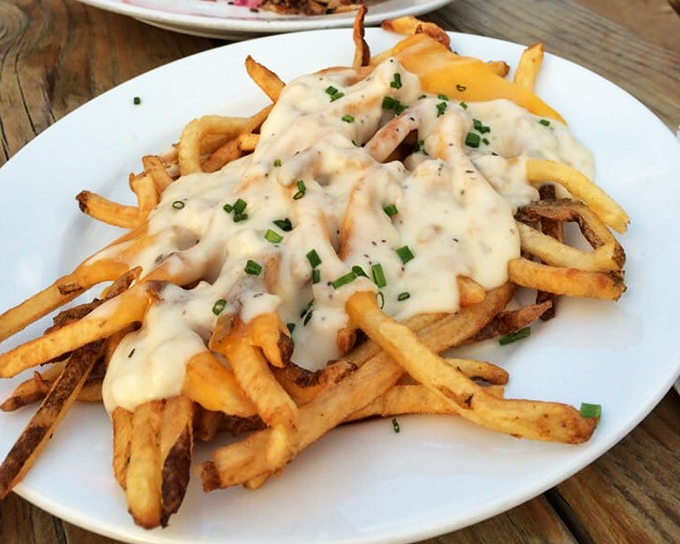 Fries smothered in gravy and sprinkled with chives&mdash;proof that sometimes the most beautiful relationships are the messiest ones.