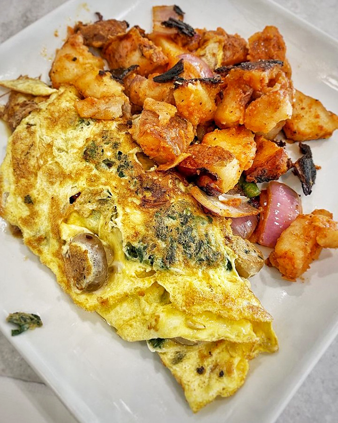 This omelet whispers sweet nothings to those crispy home fries, creating a breakfast romance that's impossible to resist.