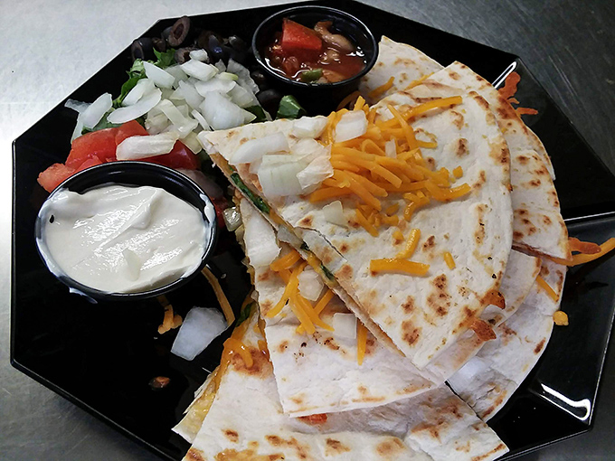 Quesadillas that achieve the golden ratio of cheese pull to tortilla crunch. The accompanying salsa and sour cream are not optional&mdash;they're essential supporting characters.