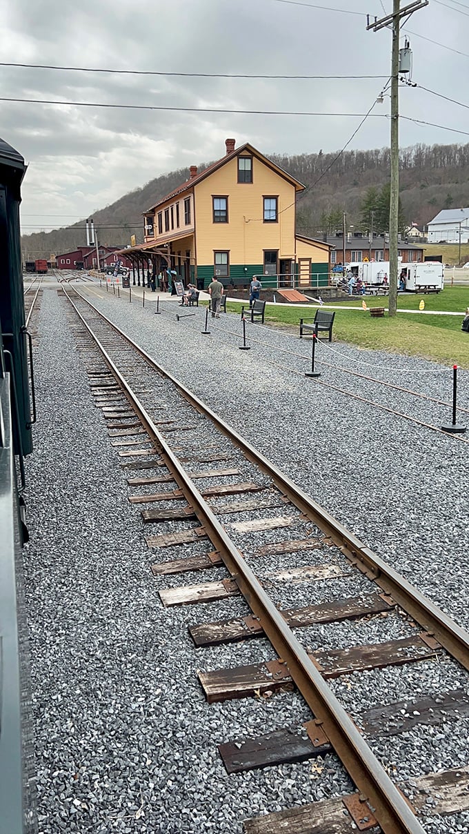 The station stands sentinel against the hillside, its mustard-yellow facade a beacon for travelers seeking both adventure and history.