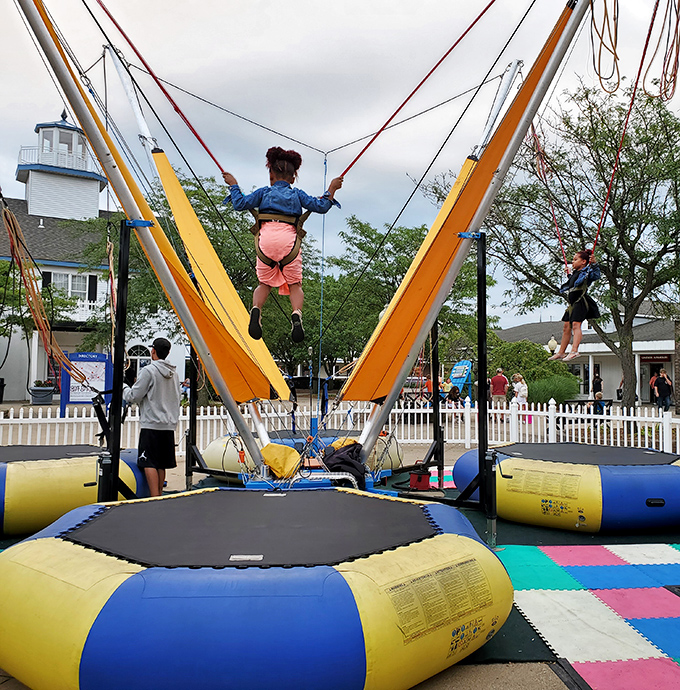 The bungee jump attraction: where kids burn energy while parents' credit cards cool down between stores.