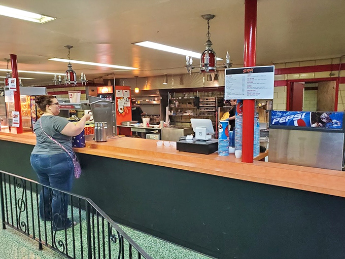 The concession counter beckons with promises of hot, salty, sweet indulgences that taste better when eaten during previews.