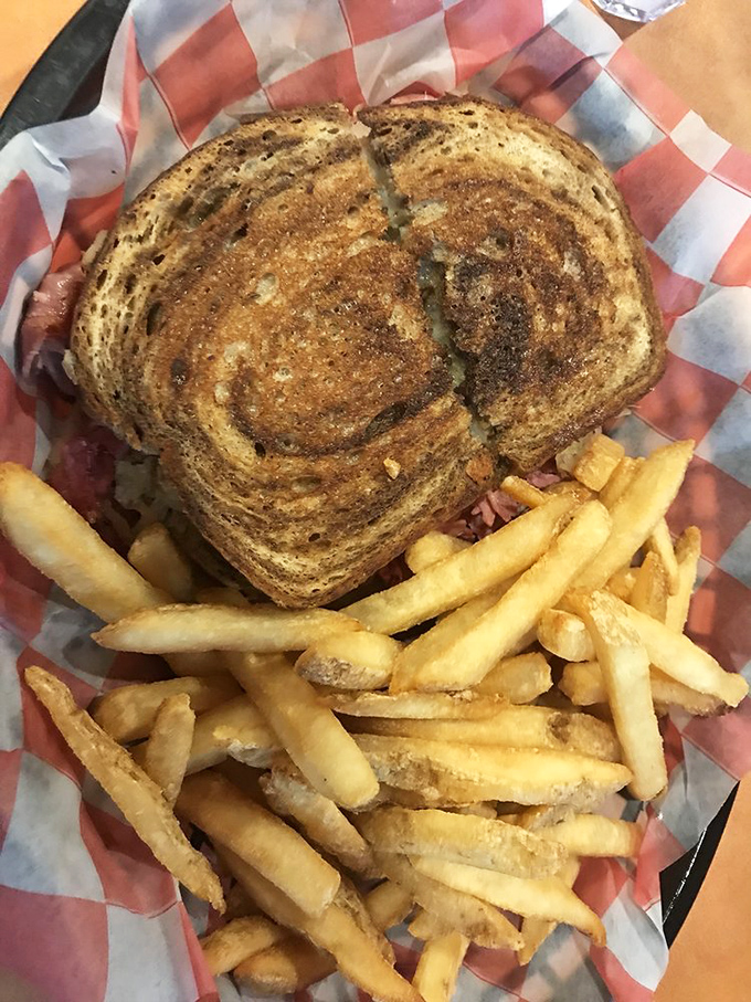 The Reuben sandwich&mdash;where sauerkraut, corned beef, and Swiss cheese hold their annual meeting with a side of crispy fries.