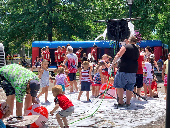 Summer fun erupts in foamy delight as children splash through community festivities, creating memories that will outlast the season's heat.