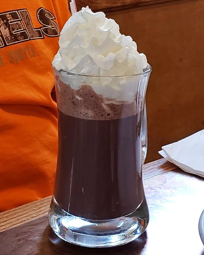 A root beer float that towers with possibility. That mountain of whipped cream isn't just a topping—it's a declaration of dessert independence.