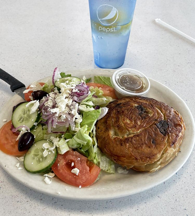 A Greek salad and savory pastry that proves healthy-ish options exist even in diners, though nobody's counting calories after midnight.