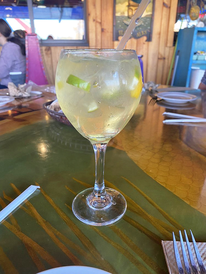 A refreshing lime-garnished cocktail that promises to cool you down while the seafood heats things up &ndash; summer in a glass.