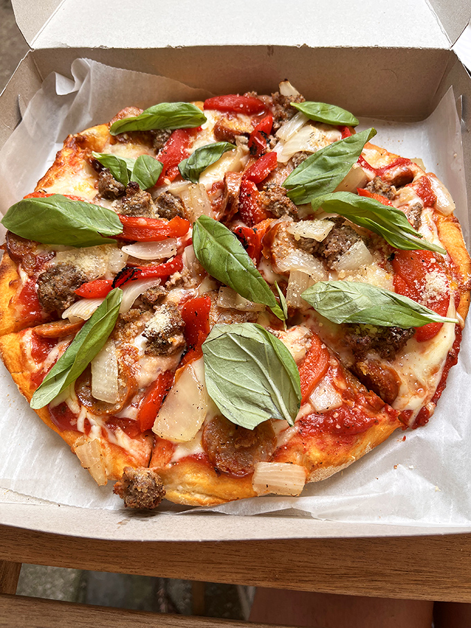 Fresh basil leaves dancing atop a meat lover's dream—proof that vegetables and carnivorous delights can coexist beautifully.