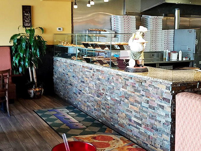 Where pizza dreams come to life – the open kitchen counter showcases pies waiting for their moment of glory.