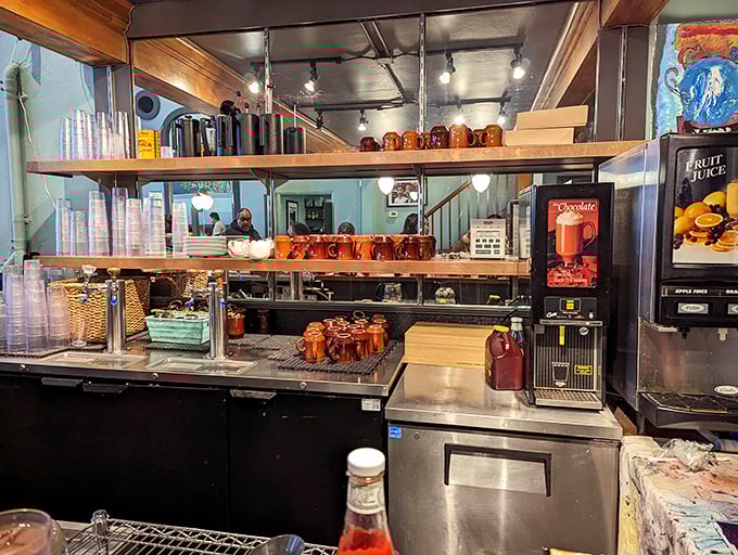 The service counter showcases the organized chaos of a well-run breakfast joint. Those brown mugs stand ready for their caffeinated duty.