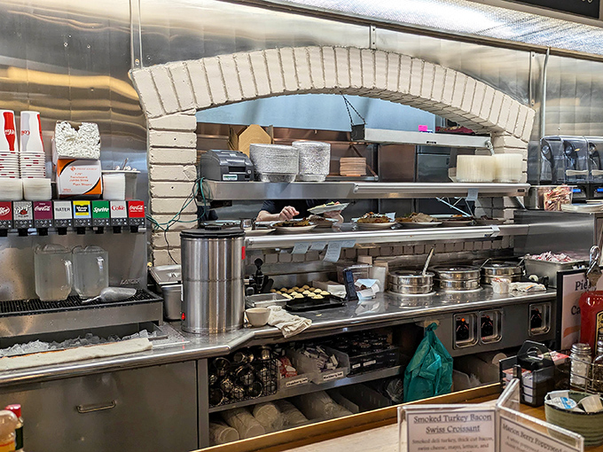 The kitchen pass&mdash;where culinary magic happens behind stainless steel, each order emerging like a gift from unseen hands.