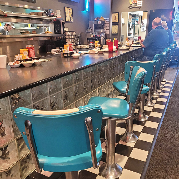 The counter seating&mdash;those turquoise chairs against checkerboard floors&mdash;isn't just nostalgic; it's where solo diners become temporary members of the breakfast club.