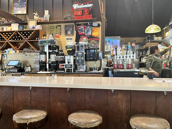 The service counter doubles as a museum of roadside Americana, where coffee flows as freely as motorcycle stories.