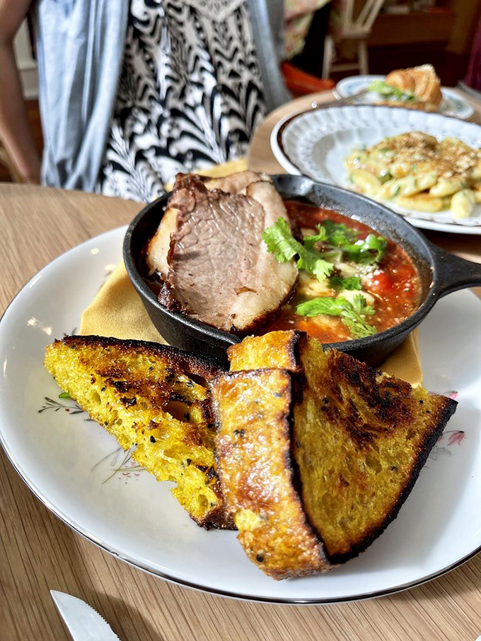 Shakshouka served in a cast-iron skillet with golden toast—the kind of rustic comfort that makes you want to linger.
