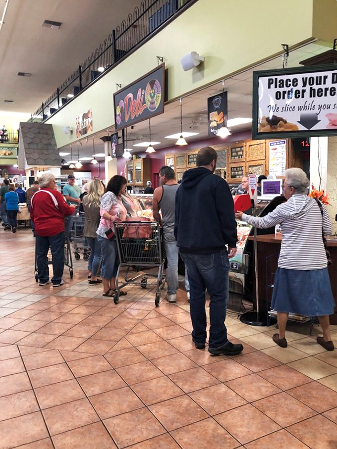 The deli counter draws a crowd for good reason—where else can you watch your sandwich dreams materialize before your eyes?