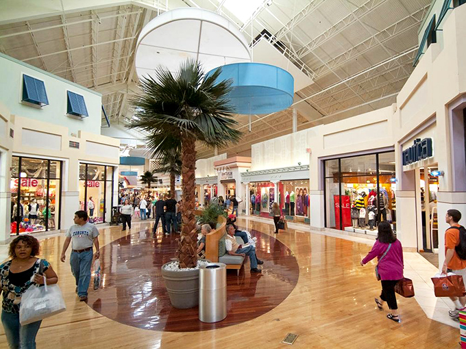 The polished floors reflect both the mall's cleanliness and the determined expressions of shoppers on a mission.