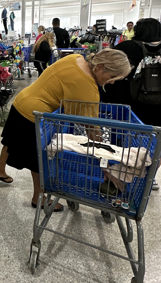 The treasure hunt in action. That focused expression says it all&mdash;she's not shopping, she's discovering.