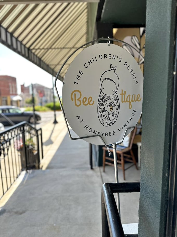 "The Children's Resale" sign swings gently in the breeze, promising tiny treasures for the next generation.