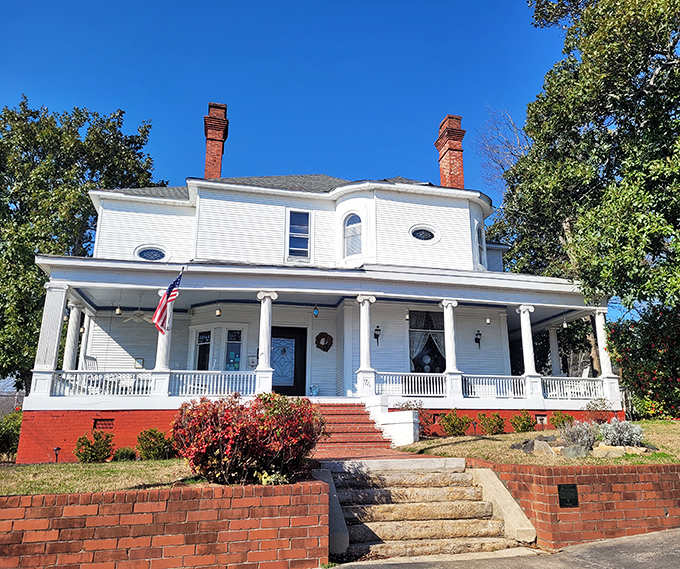 This stately white Southern home with wraparound porch whispers stories of bygone eras. Columns and comfort combine in a postcard-perfect bed and breakfast.