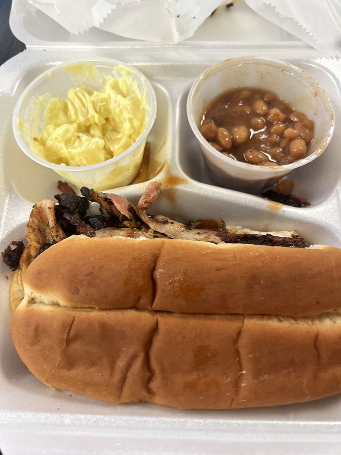 A pulled pork sandwich with sides that deserve equal billing. In Memphis, this is what happiness looks like on a styrofoam plate.
