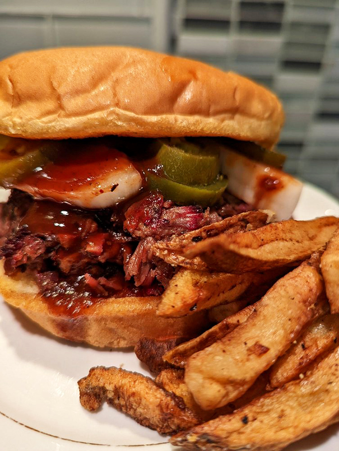 A sandwich that requires both hands and possibly a bib. When barbecue sauce on your shirt becomes a badge of honor.
