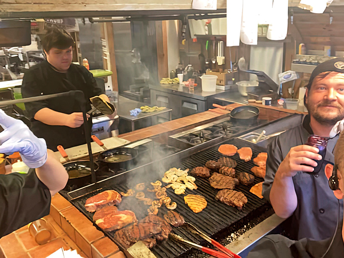 Behind the scenes where the magic happens&mdash;steaks sizzling on the grill while the chef orchestrates a symphony of flame and flavor.
