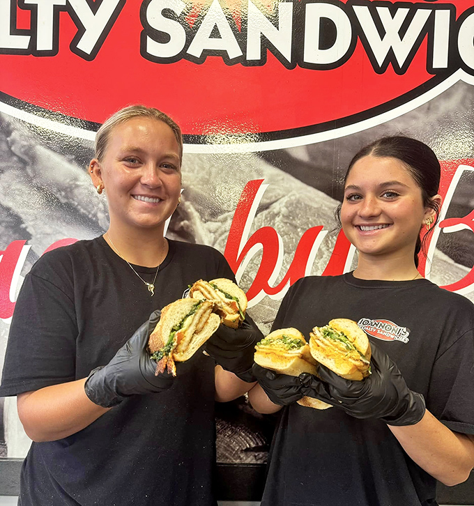 The sandwich artists at work&mdash;where black gloves signal serious business and smiles signal genuine pride in their craft.