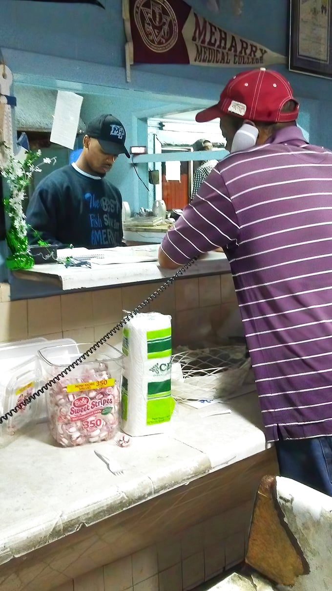 Where the magic happens. That focused expression says, "I've made thousands of these sandwiches, and yours will be perfect too."