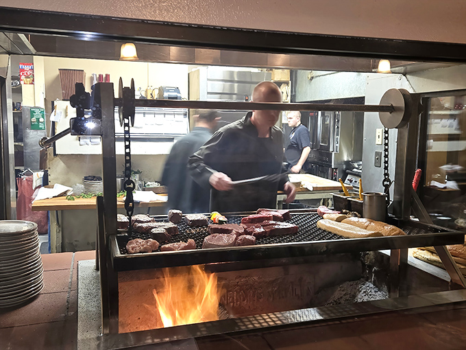 The open kitchen reveals the heart of The Hitching Post—where skilled grill masters orchestrate a dance of flames and meat that's equal parts science and sorcery.