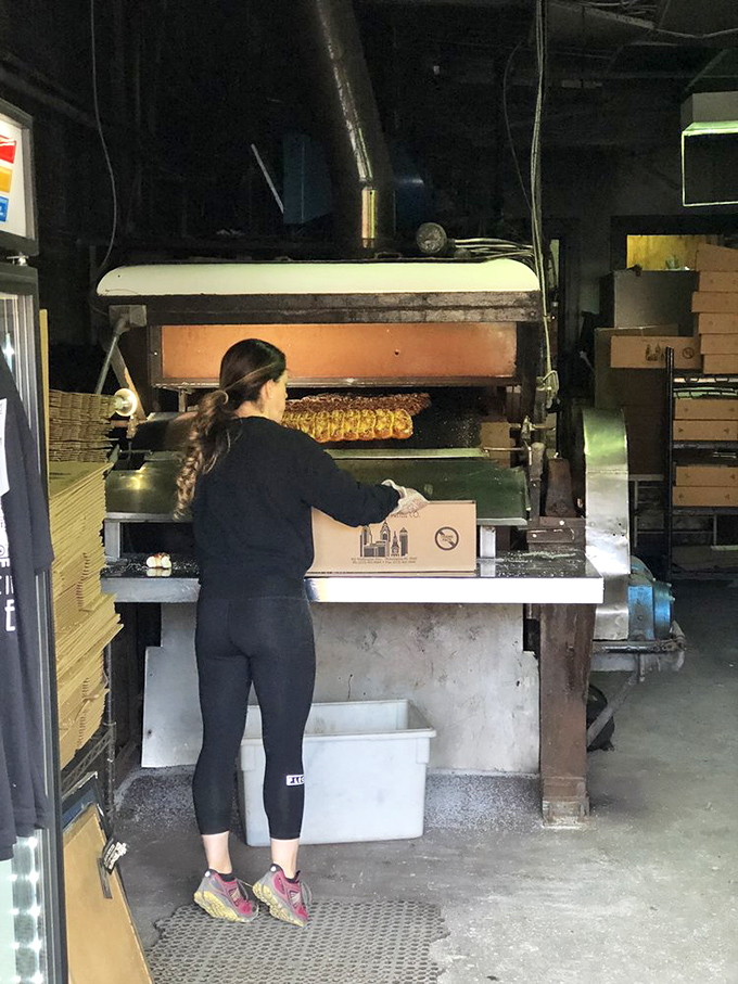 Behind every great pretzel is a dedicated baker. The oven's warm glow illuminates the time-honored process that hasn't changed for generations. 