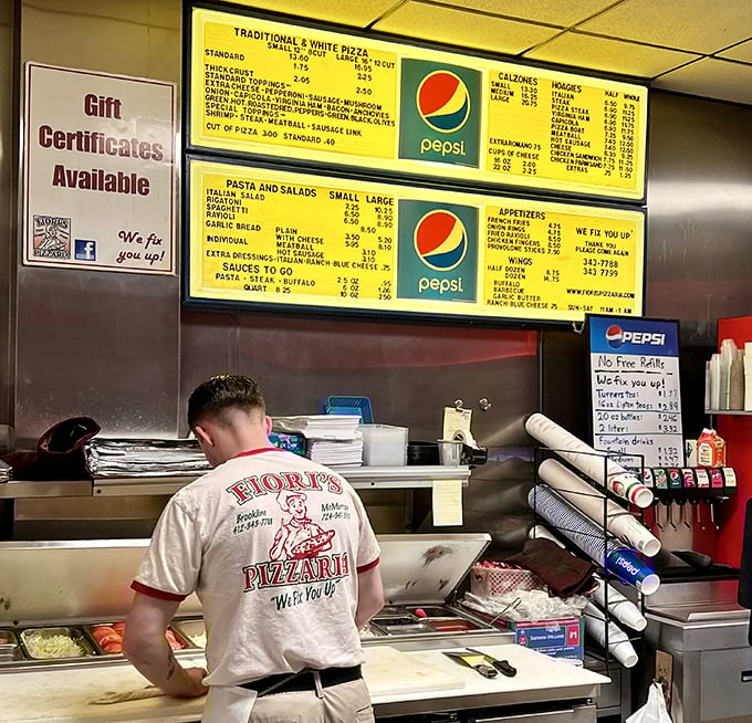 The back of a Fiori's shirt says it all&mdash;"We Fix You Up"&mdash;as staff prepare the day's therapy sessions one pizza at a time.