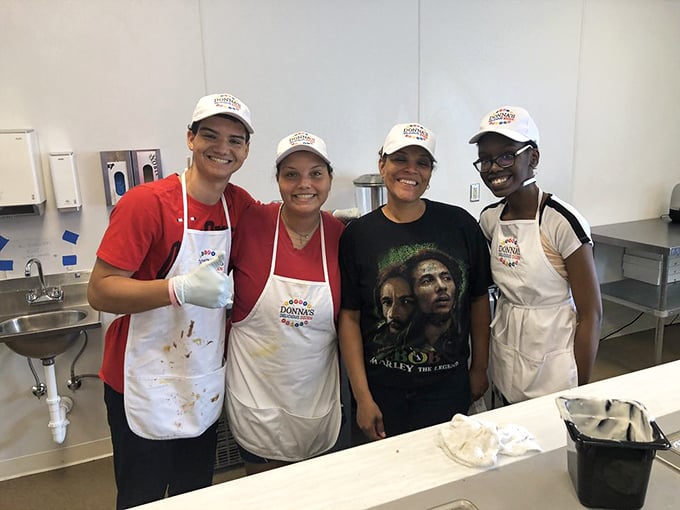 The talented team behind the magic, wearing their Donna's caps like the culinary superheroes they truly are.
