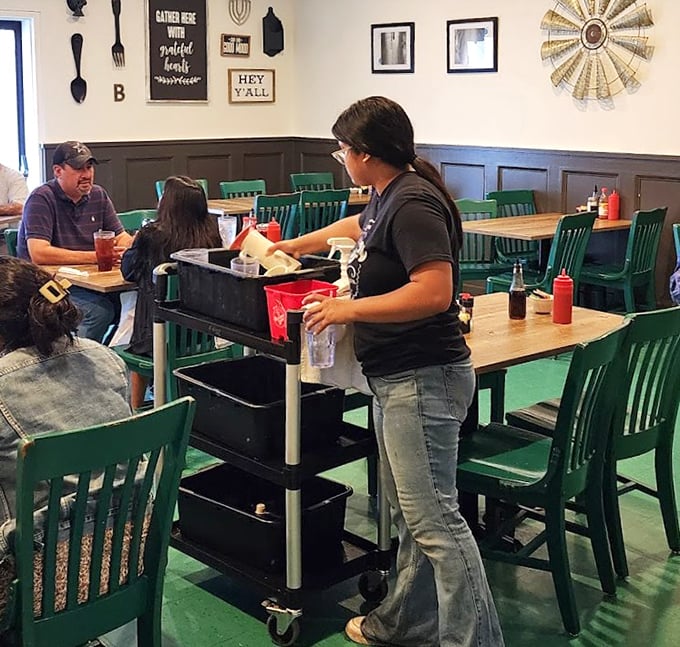 Green chairs against cream walls create the perfect backdrop for servers who deliver Southern hospitality alongside plates of comfort food.