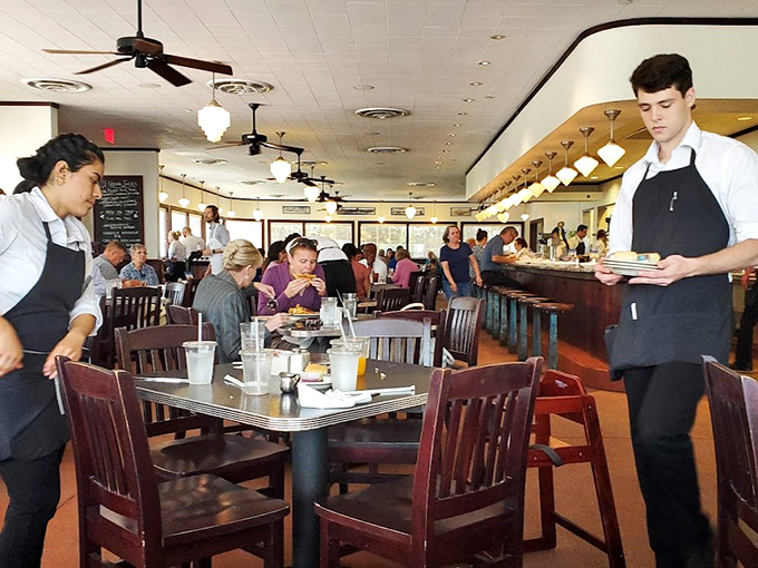 The dance of service in full swing&mdash;servers gliding between tables with plates of comfort food while diners lean into conversations worth having.