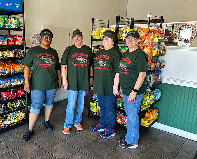 The team behind the magic, wearing their burger pride like superhero uniforms. These are the guardians of good taste.