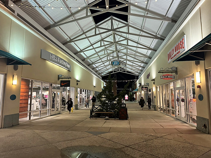 Evening at the outlets transforms ordinary walkways into runways of possibility, illuminated by the soft glow of "Additional 40% Off" signs.