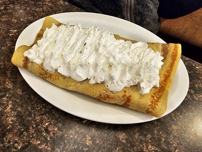 A crepe that's essentially dessert masquerading as breakfast. The whipped cream mountain makes a compelling argument for starting your day with sugar.